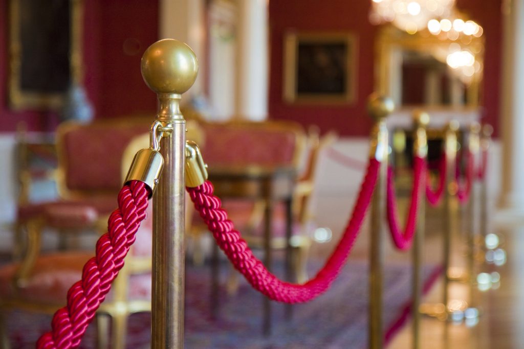 Detail of red rope on a exhibition space - defocused background concept ...